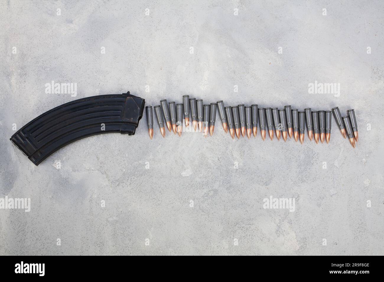kalashnikov ak47 gun magazin with 30th unloaded 7,62 mm bullets on grey ...