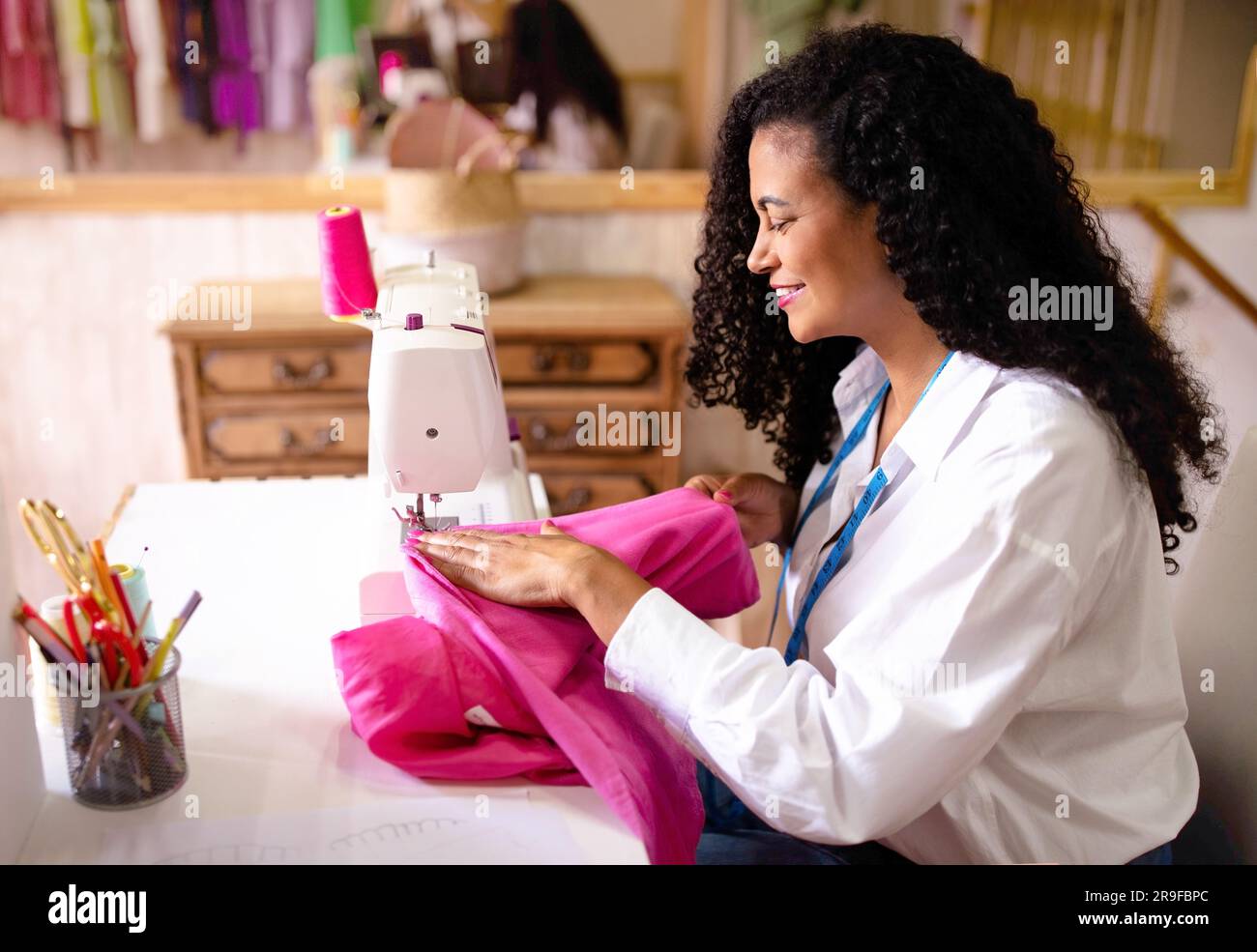 Side View Of Middle Eastern Tailor Lady Sewing Garment Indoor Stock ...