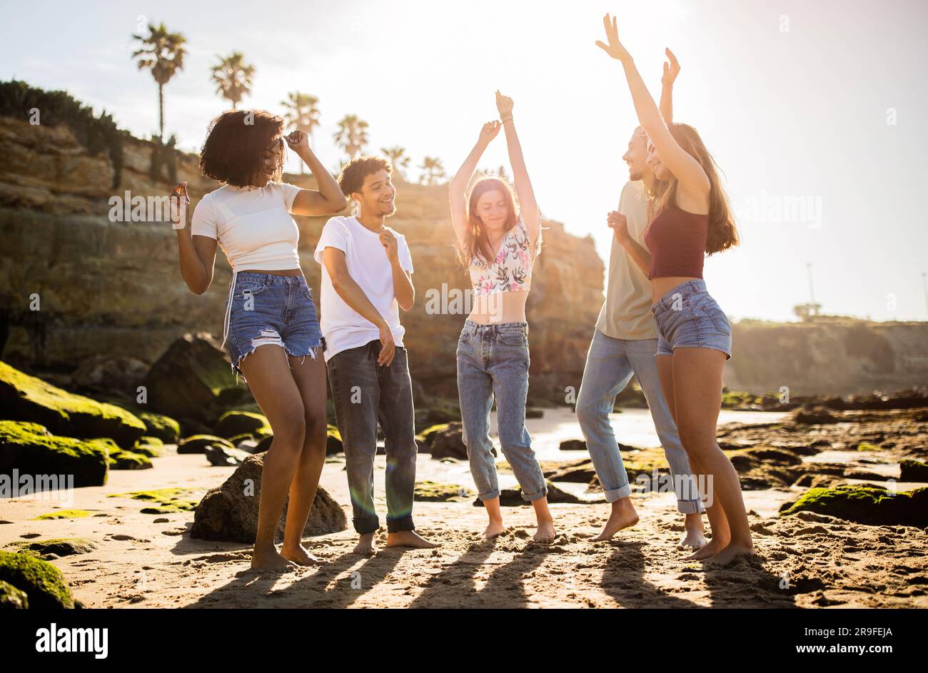Cheerful millennial black, arab, caucasian people students enjoy summer ...
