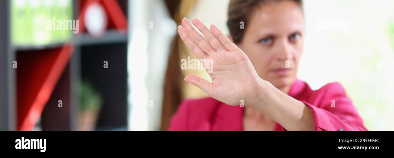 Serious woman showing stop sign, protesting against domestic violence ...