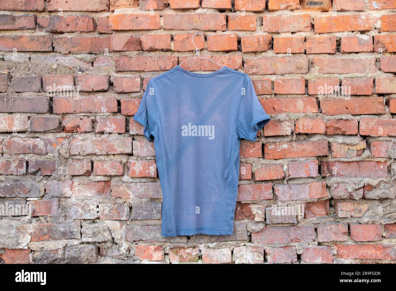 Hand hanging blue jacket on hi-res stock photography and images - Alamy