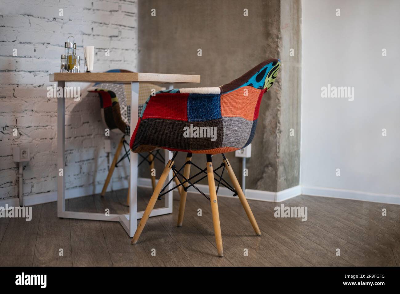 table with hand-covered armchair in the corner of office modern ...