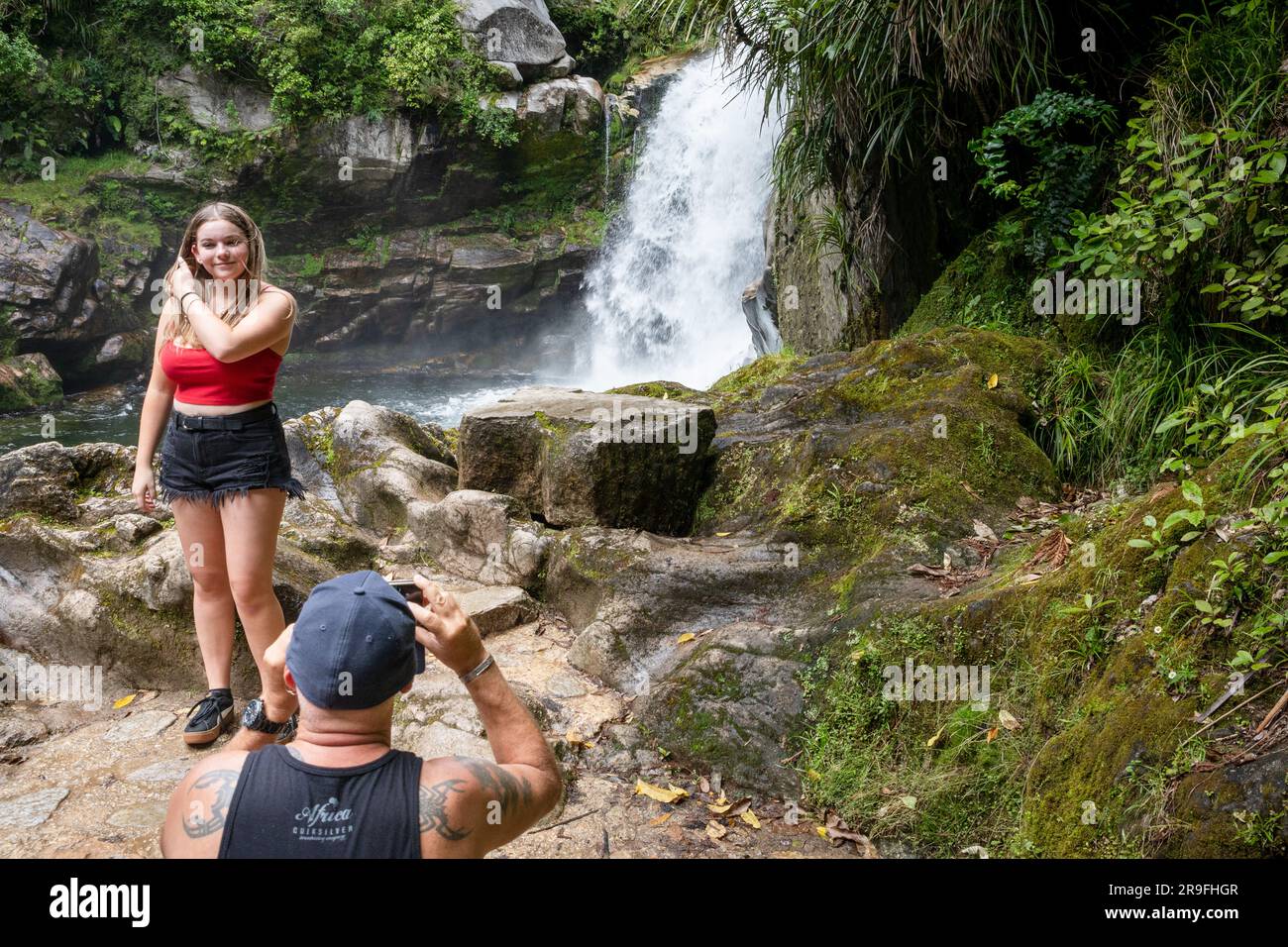 A couple pose at Wainui Falls Waterfalls Wainui Bay, Tasman Region, New ...
