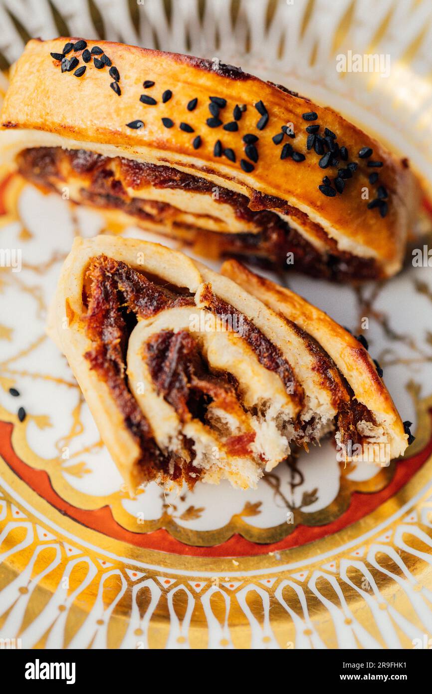 Kleicha, Iraqi date cookies in spiral form with nigella seeds on ornate ...