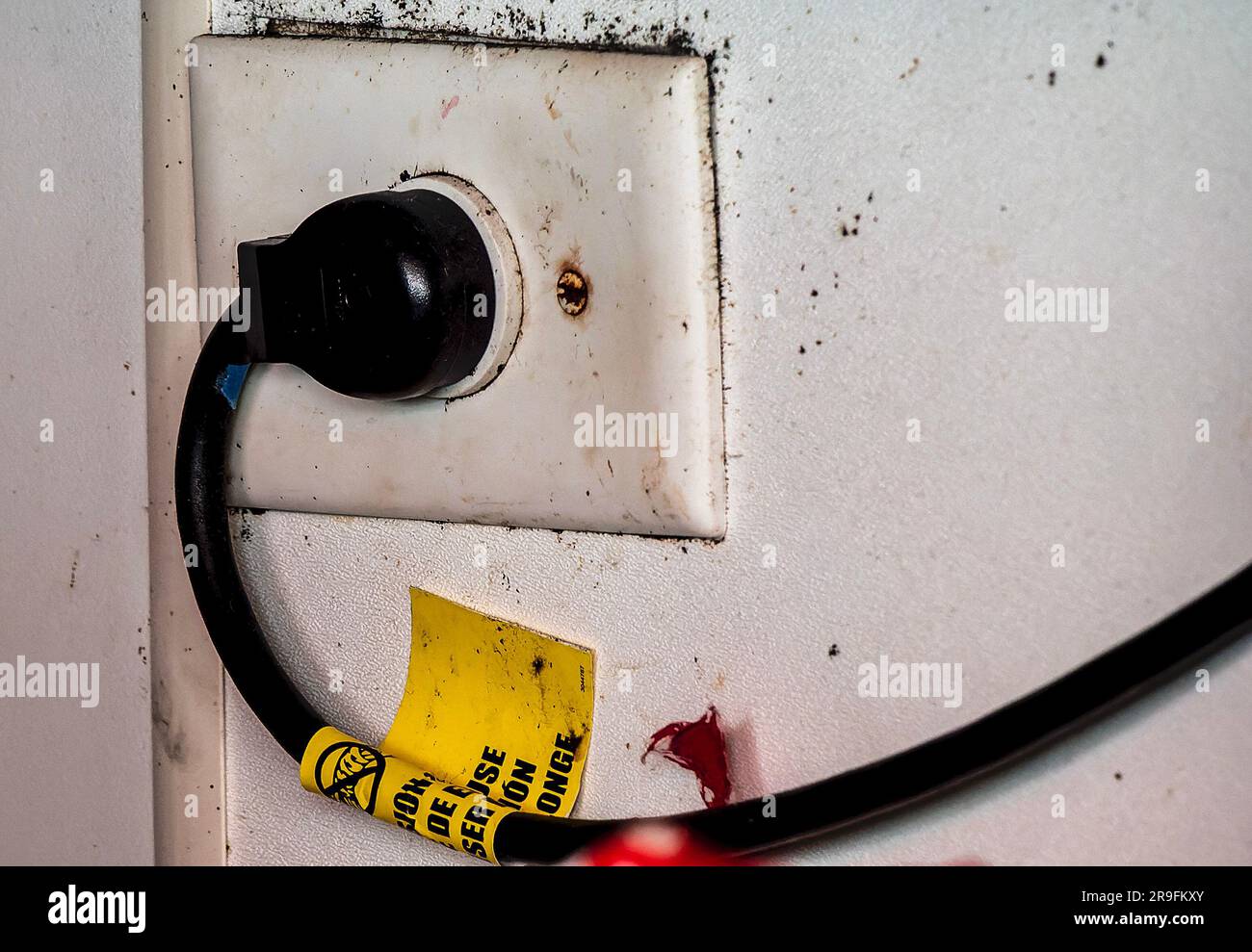 Pluggedin, electric outlet under a counter in a bar Stock Photo - Alamy