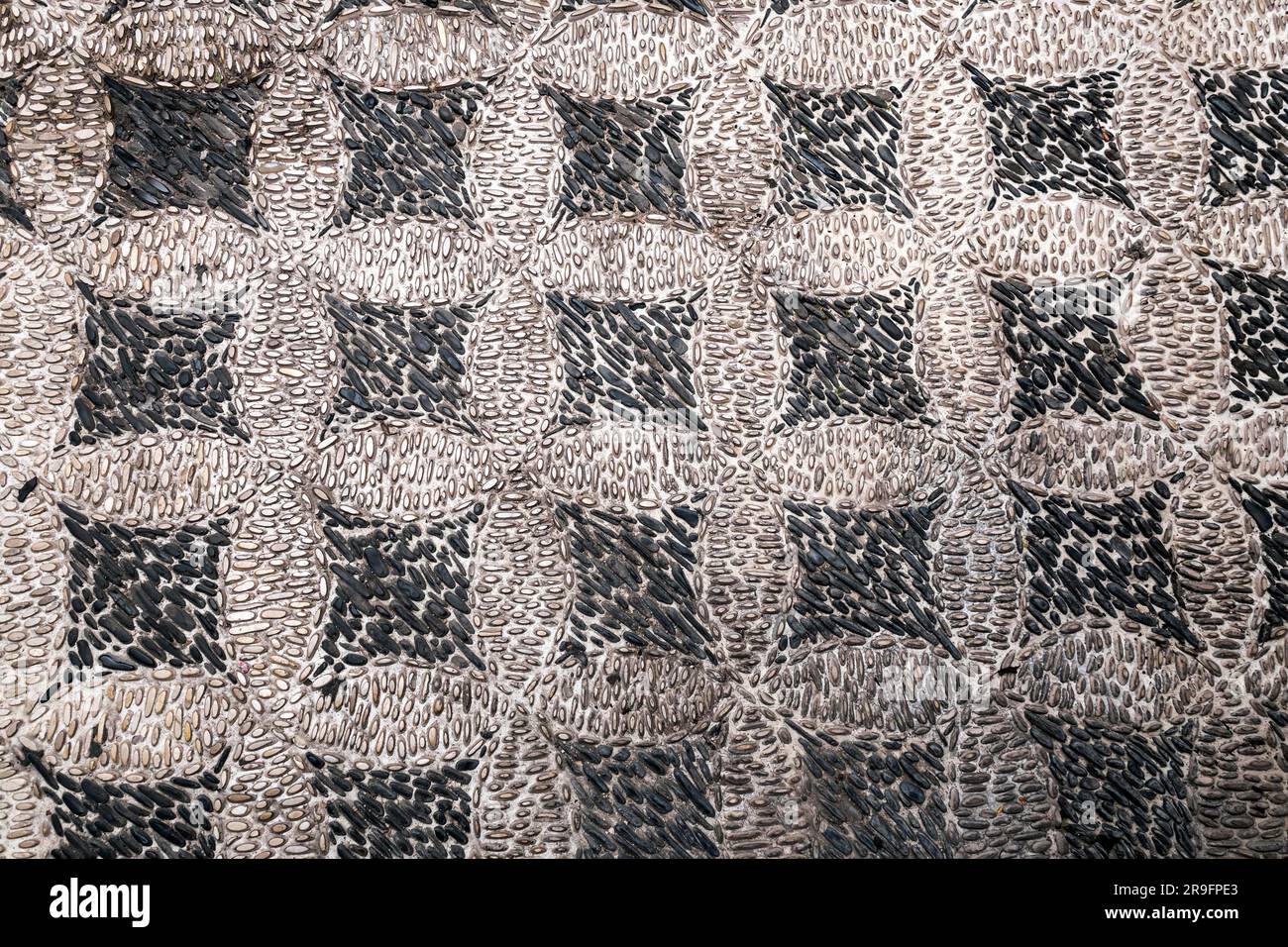 Ancient pebble pavement close up with decorative pattern Stock Photo ...