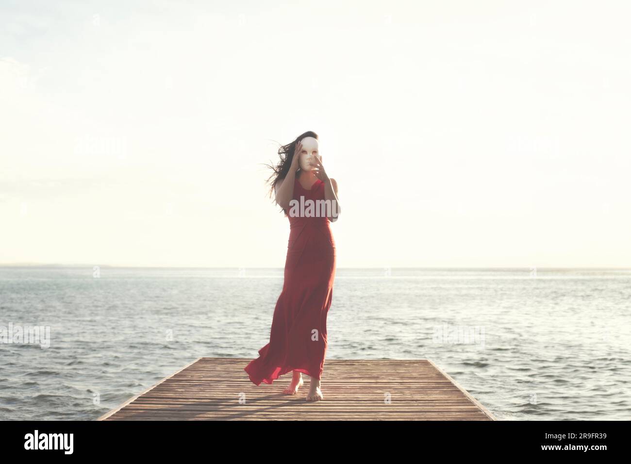 surreal woman hides her face behind a mask, identity concept Stock ...