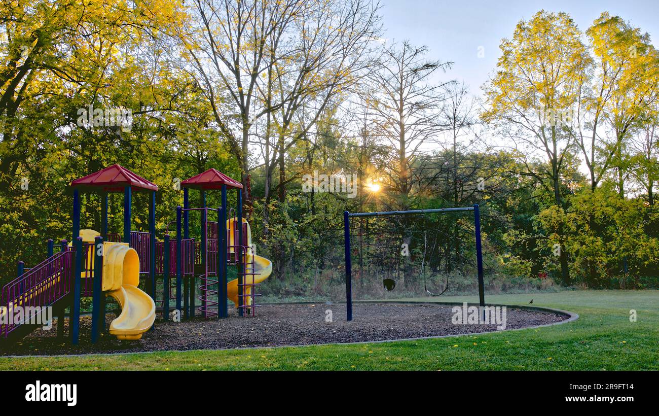 Sunrise in the public park with Slide-play equipment in the playground ...