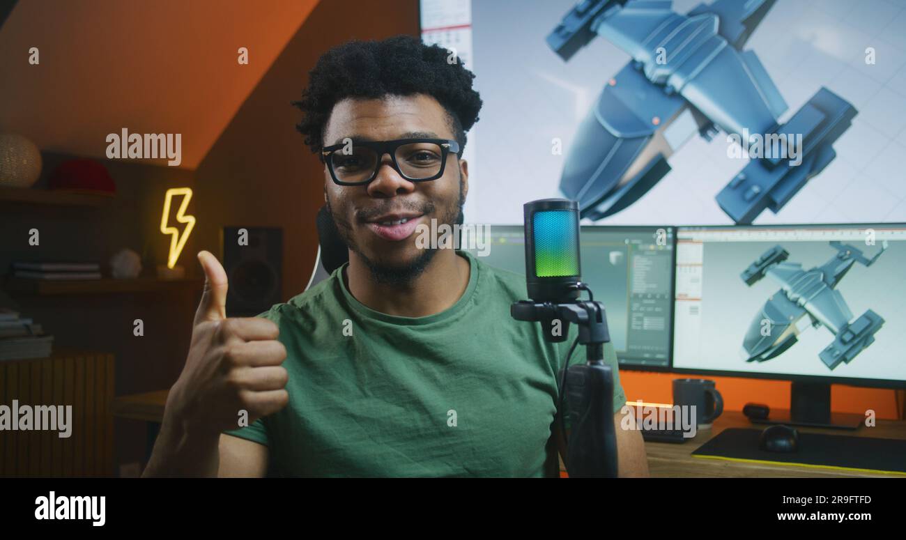 African American 3D designer speaks on camera using microphone, records video tutorial about 3D ...