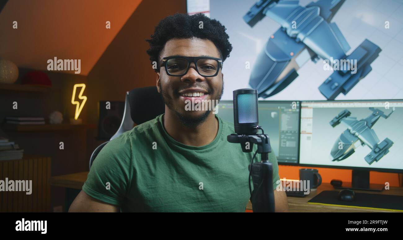 African American 3D designer speaks on camera using microphone, records ...