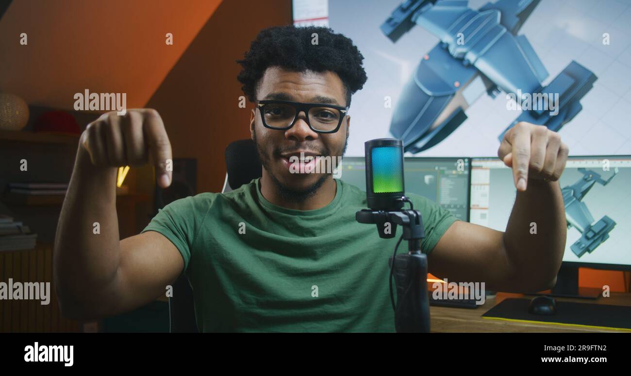 African American 3D designer speaks on camera using microphone, records ...
