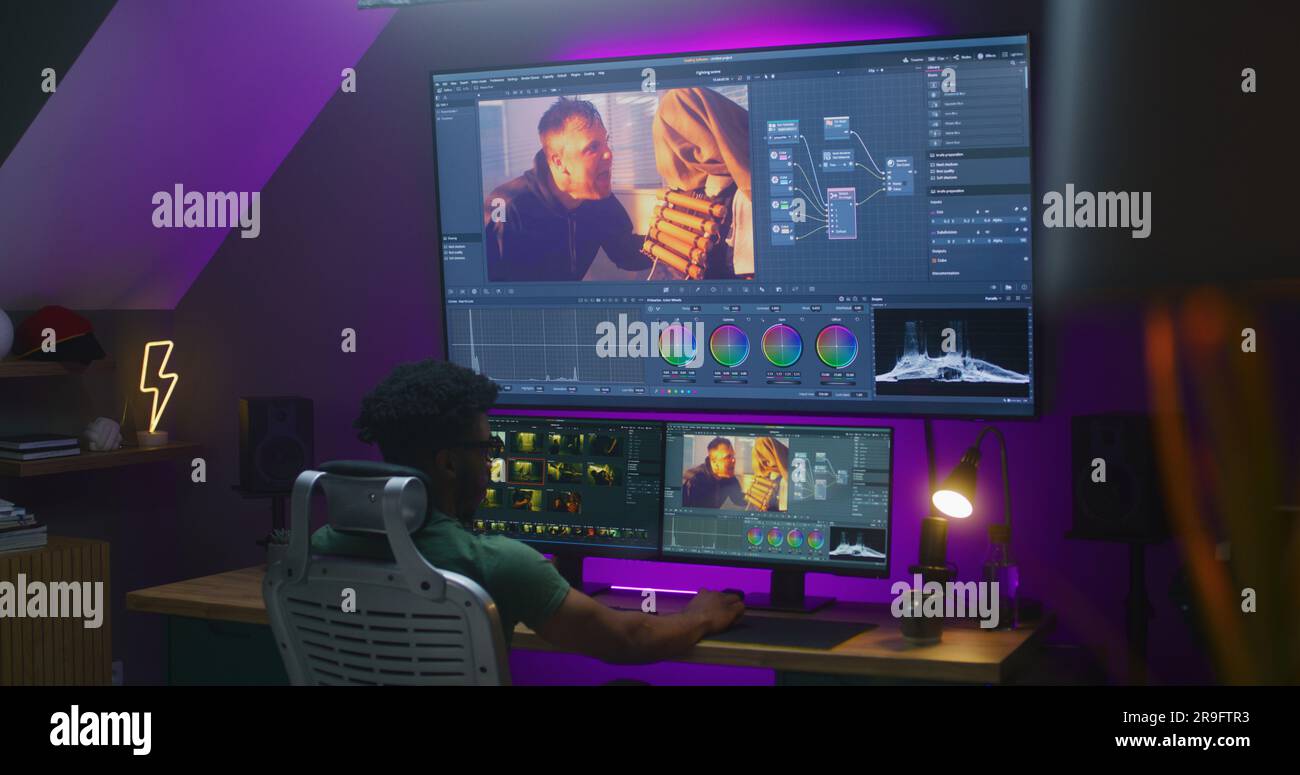 African American video maker edits action movie, makes color grading ...