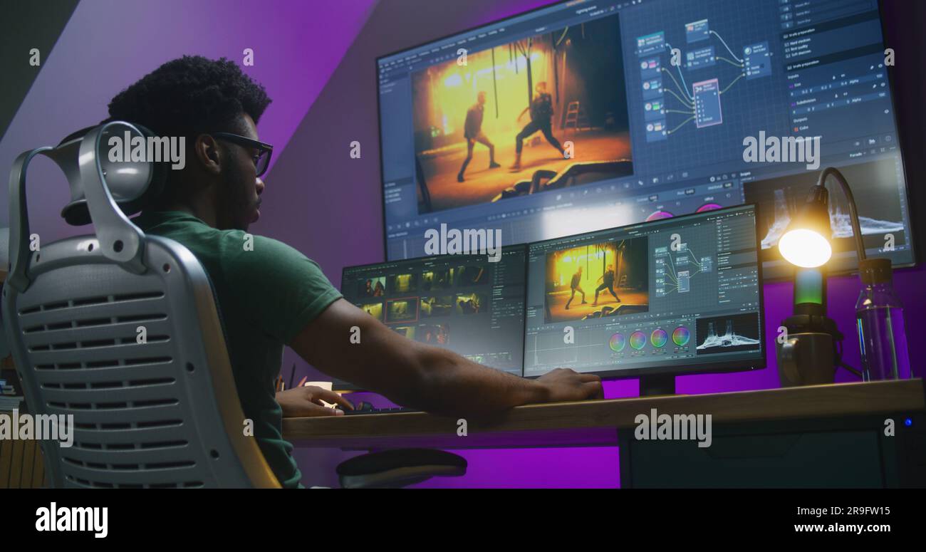 African American video editor makes color grading, works at home office ...