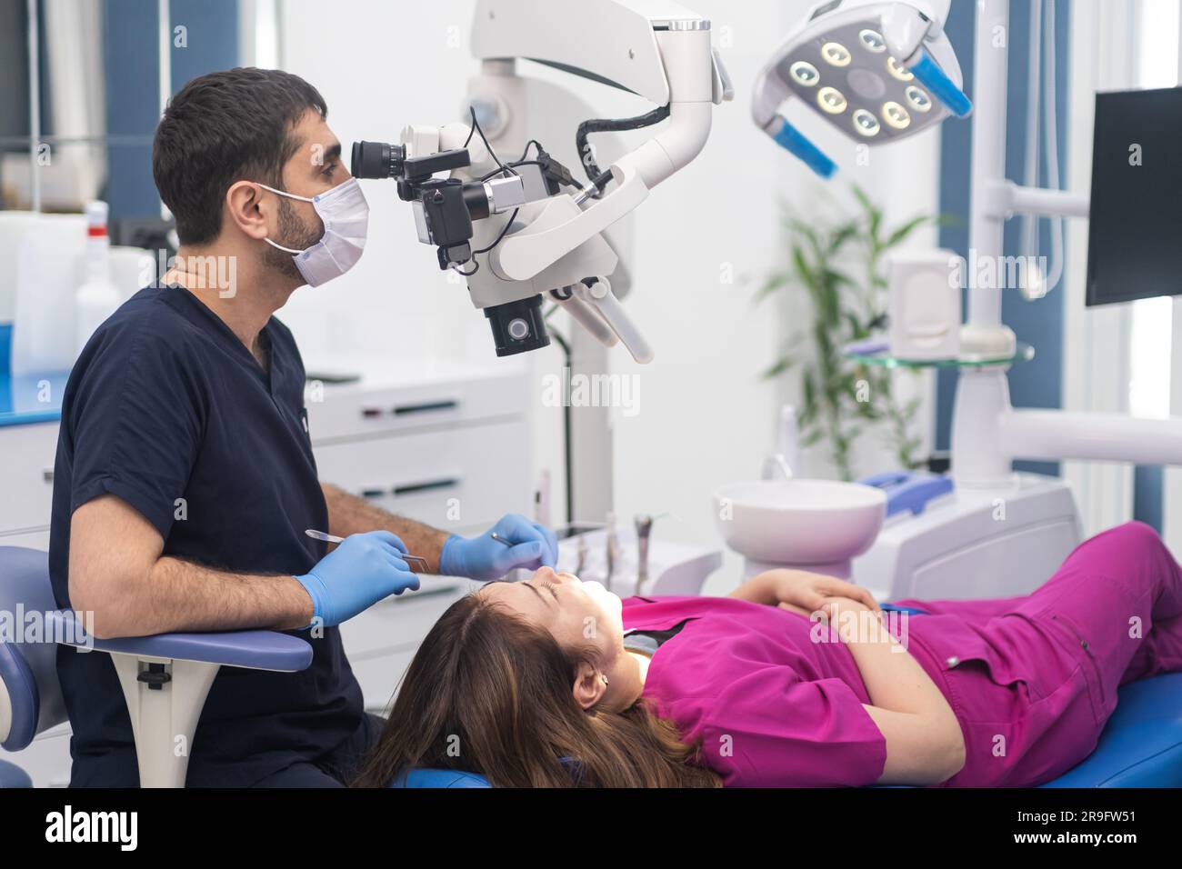 Detailed checkup of female patient cavity dentist looking in dental ...