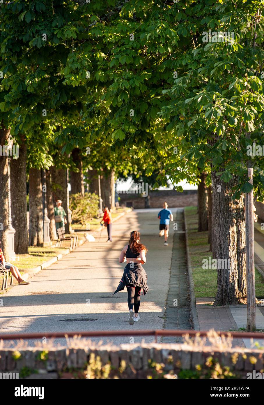 The Medici fortress walkways. People jogging in a summer afternoon ...