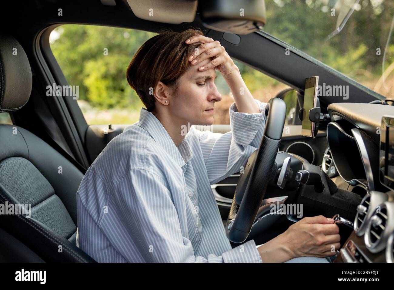Tired woman stopped after driving car, thinking about life troubles ...