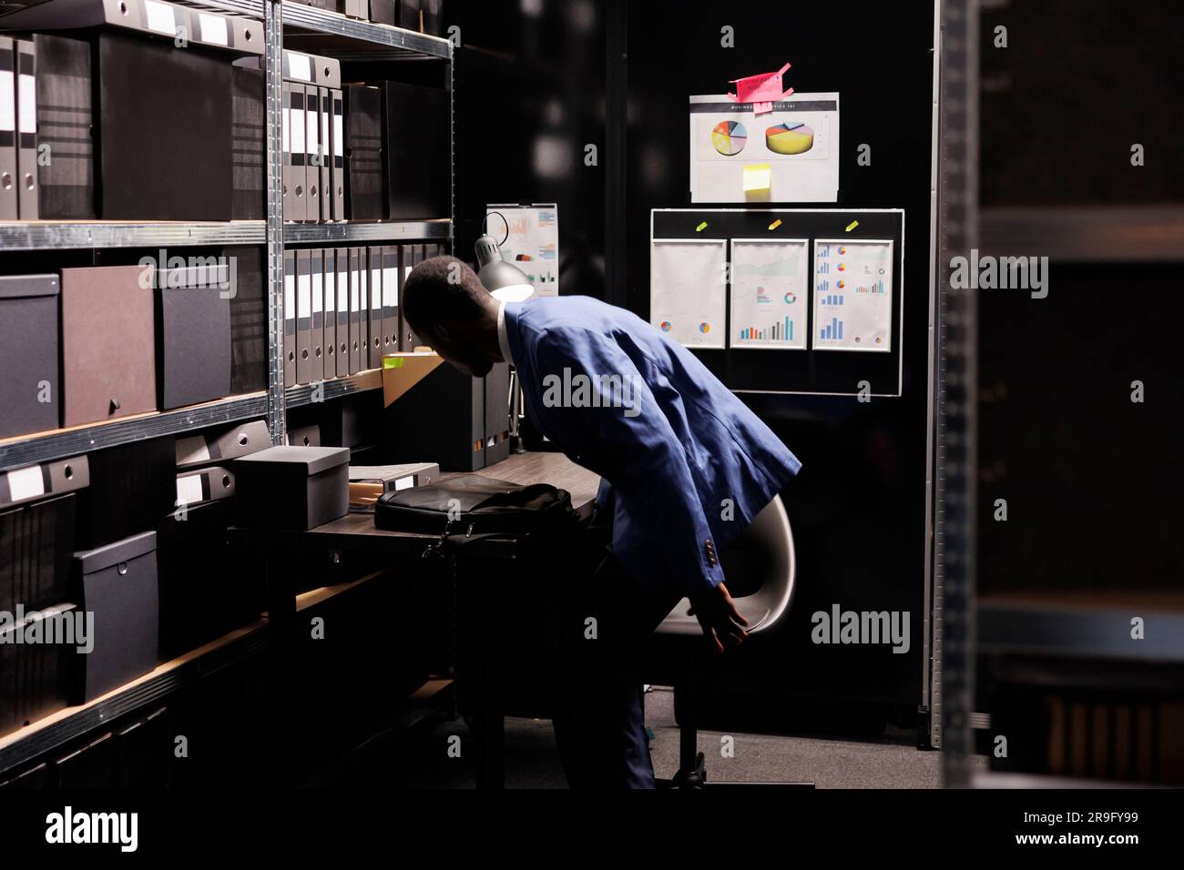 African american private detective analyzing crime case report, reading ...