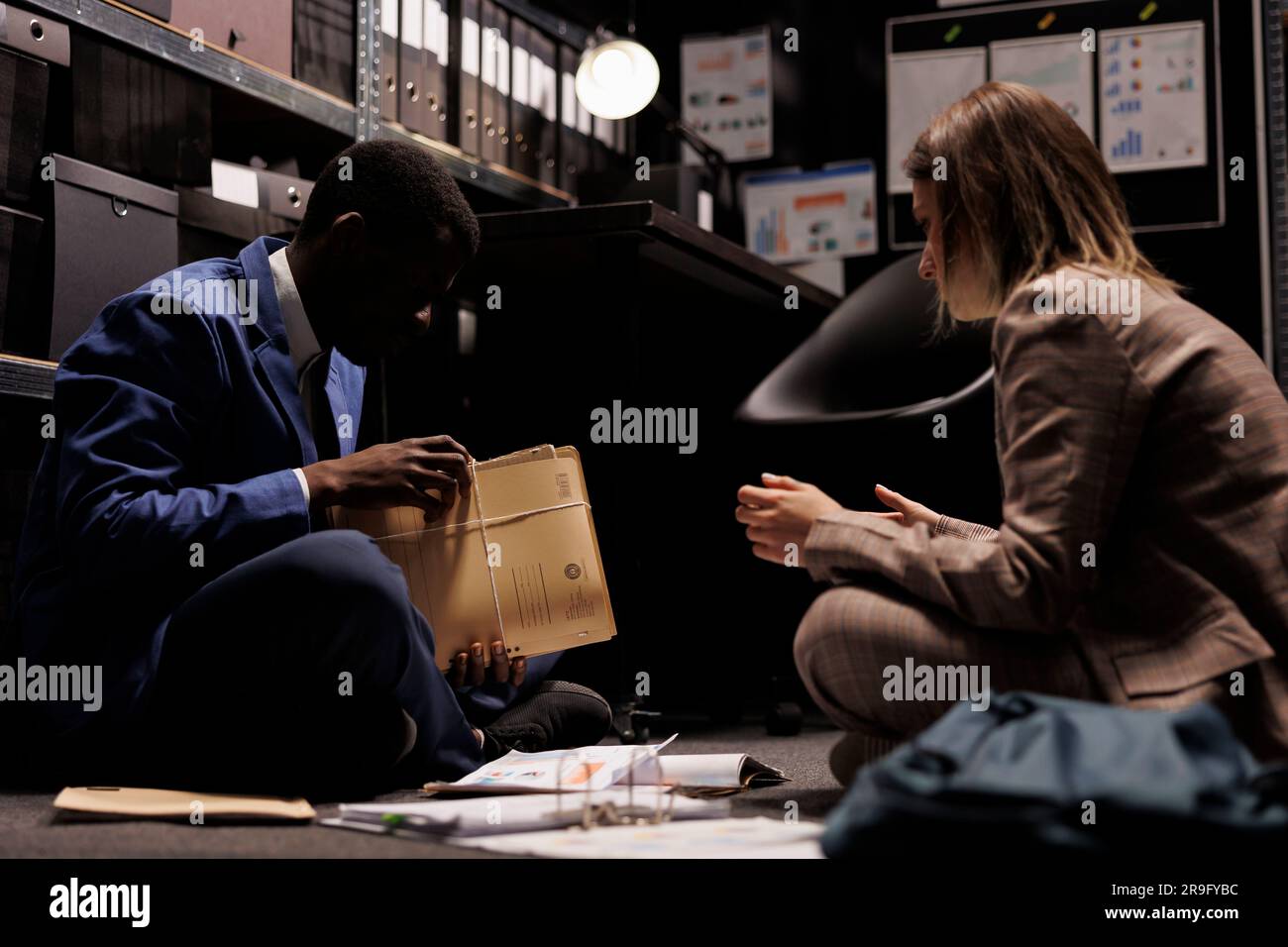 Private Detectives Working Overtime In Arhive Room Analyzing Crime Scene Evidence Discussing