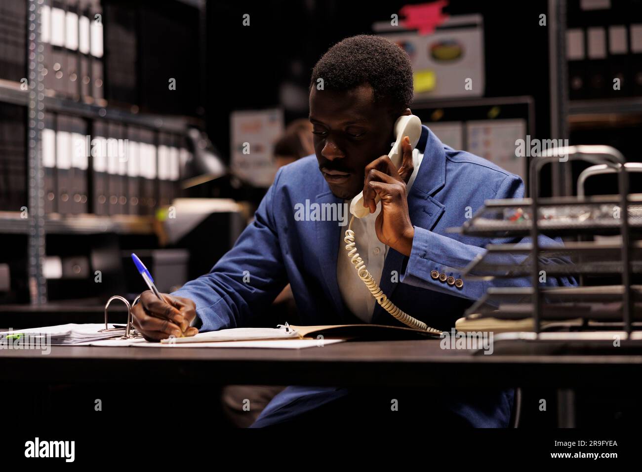 African american police officer talking with remote detective using ...
