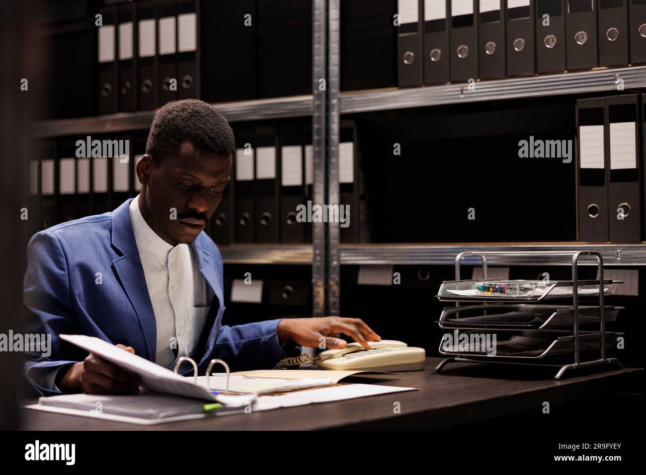 African american inspector answering phone call, discussing ...