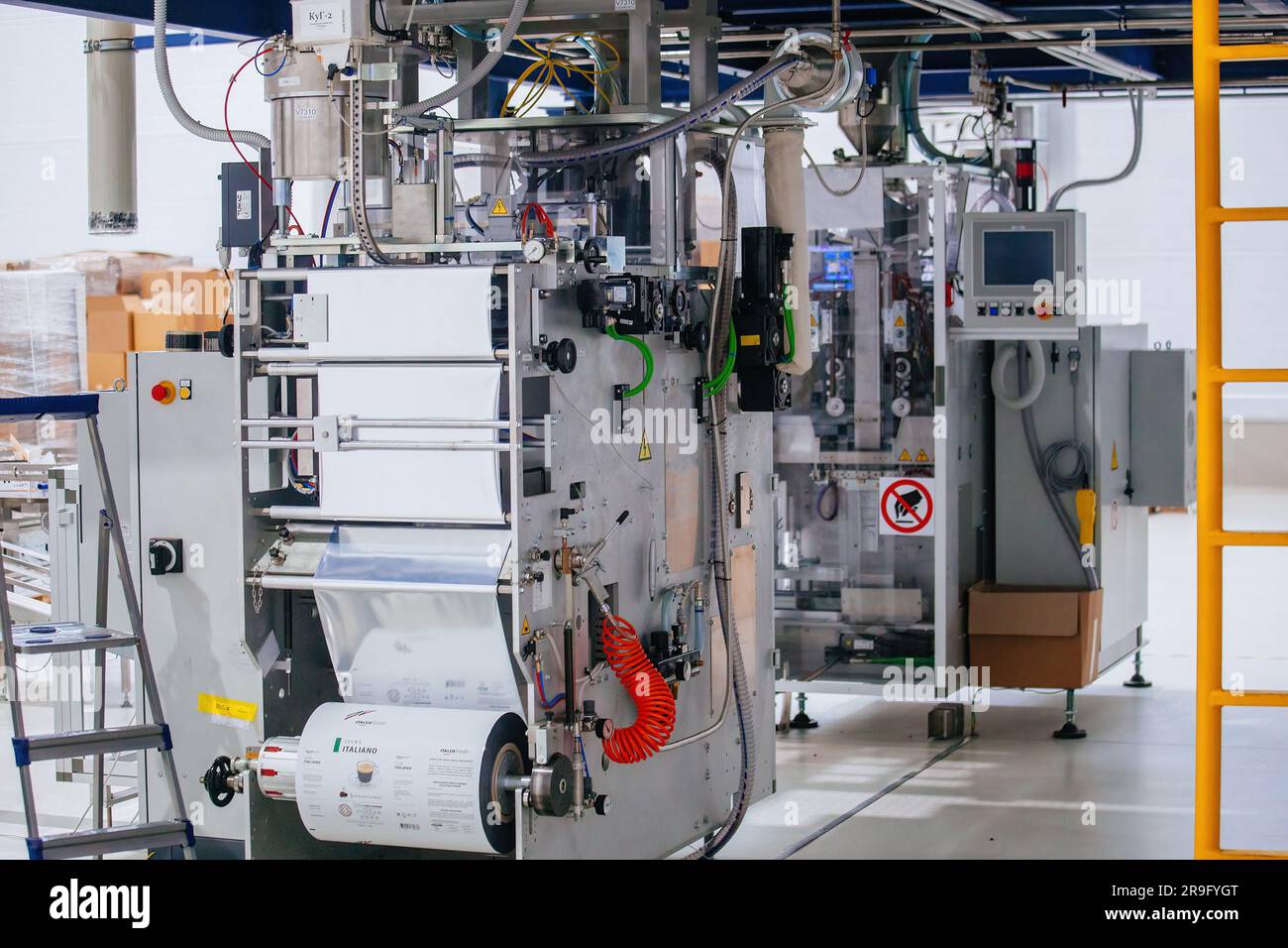 Coffee packaging, bagging and stacking machine Stock Photo - Alamy