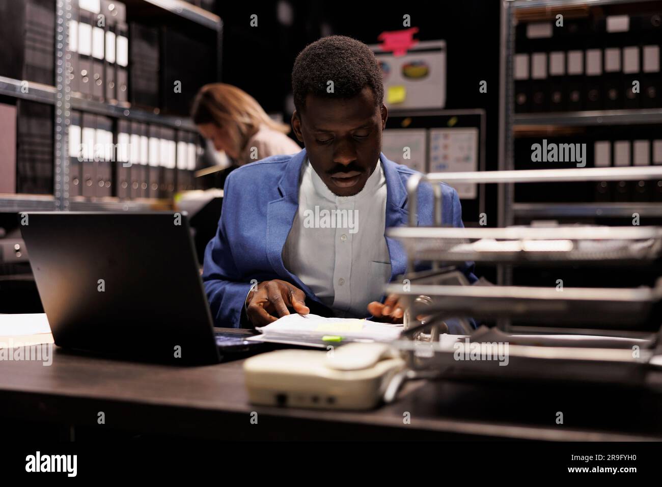 African american investigator analyzing police evidence, working ...