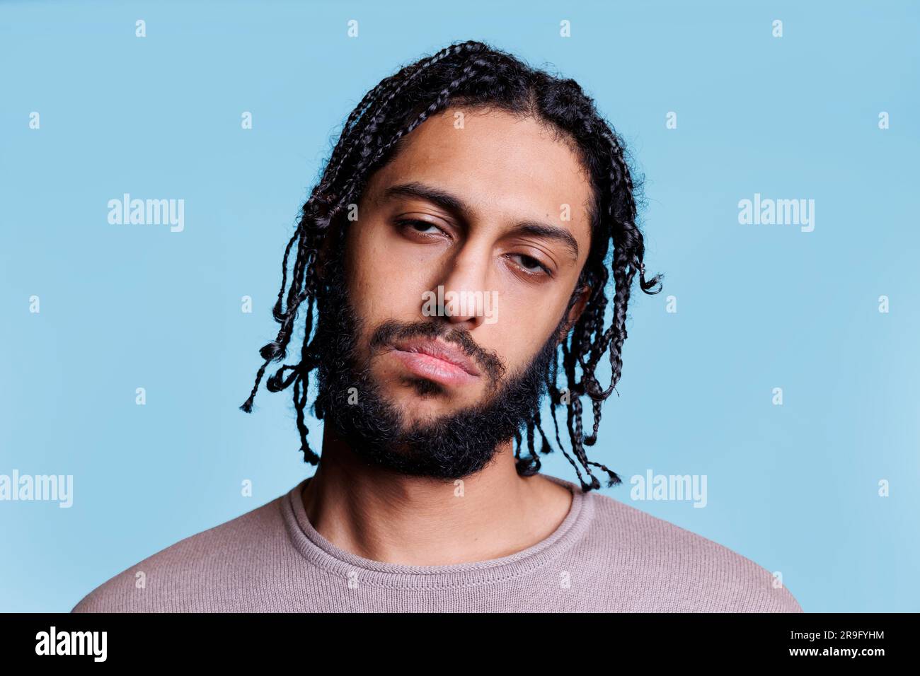 Cool confident attractive arab man tilting head with serious facial ...