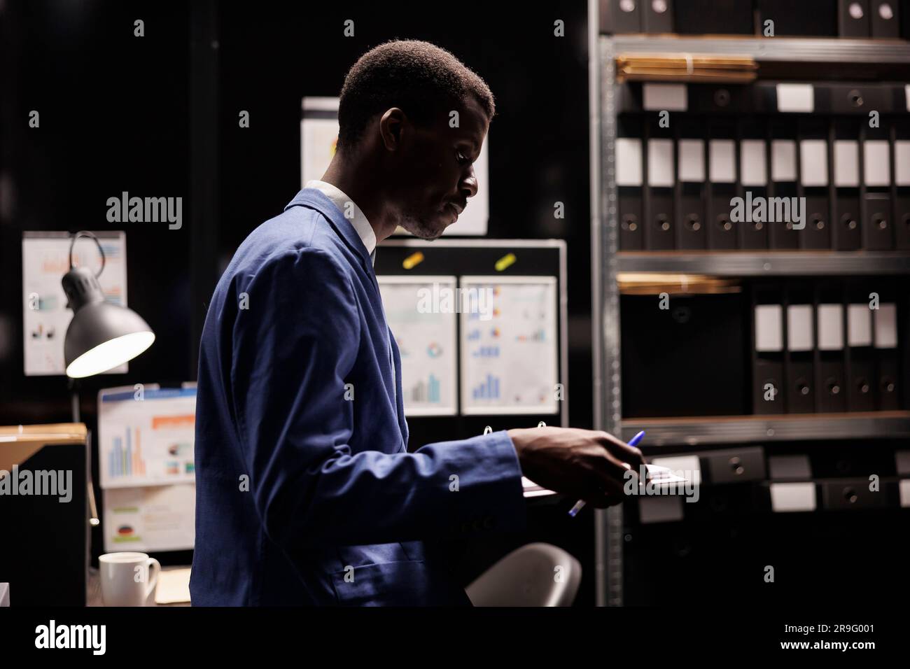 Detective checking criminology report, working at criminal case in ...