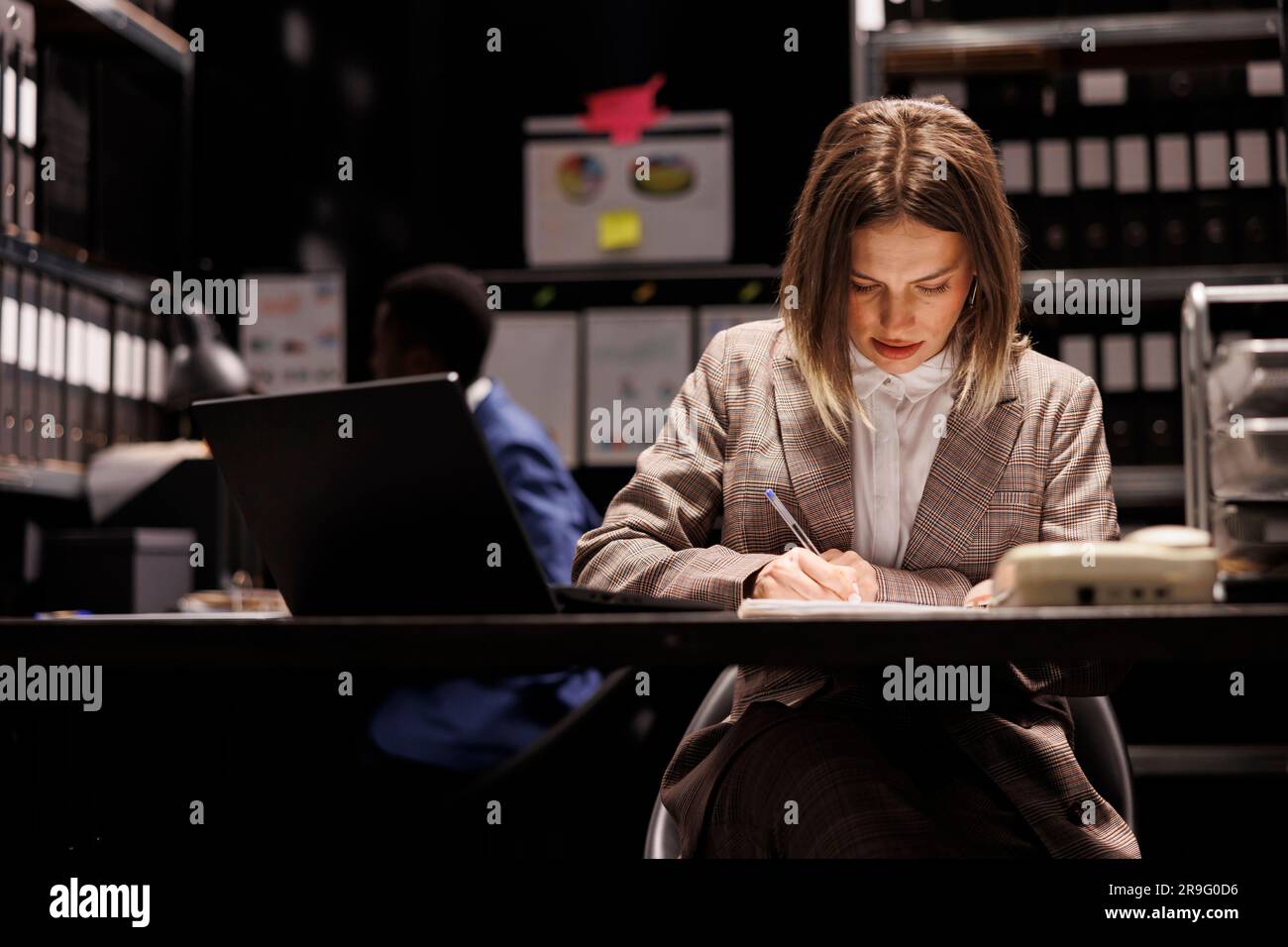 Private detective searching for new clues, working late at night at ...