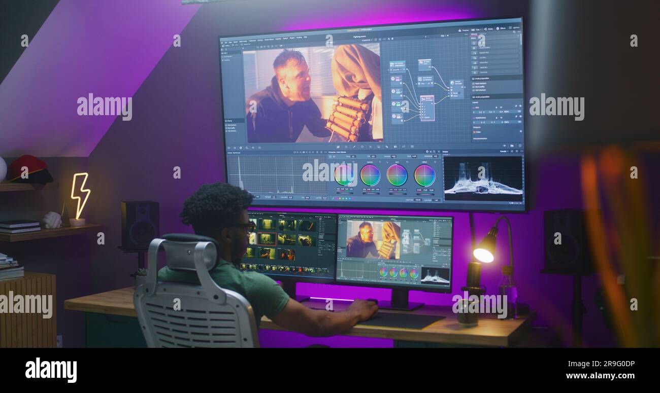 African American video maker edits action movie, makes color grading ...