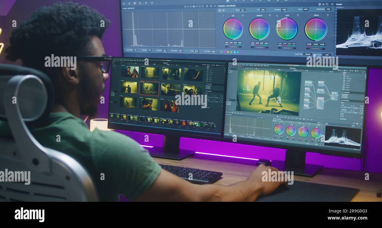 African American colorist edits action movie, makes color correction ...