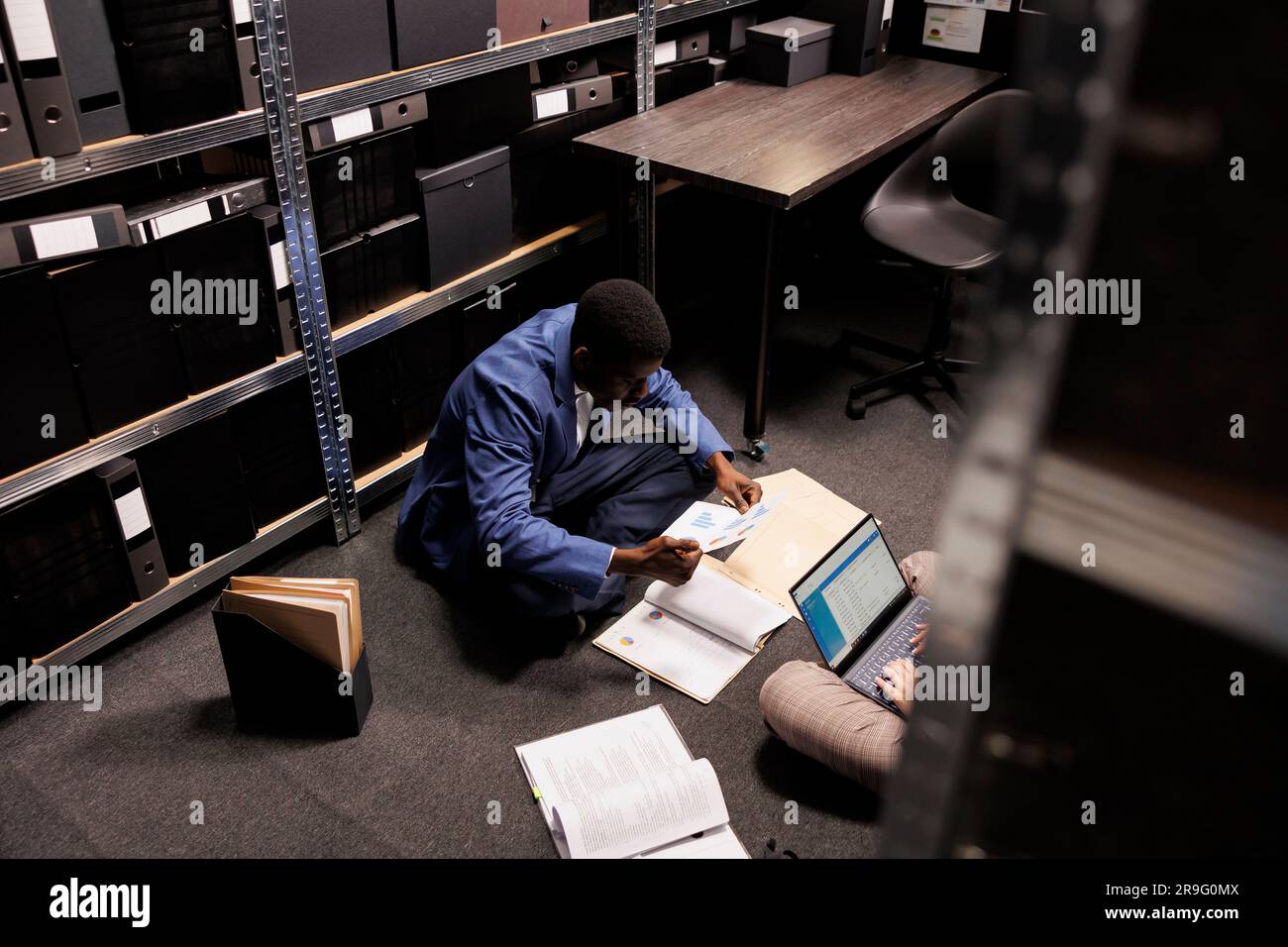 African american inspector searching for clues, analyzing crime scene ...