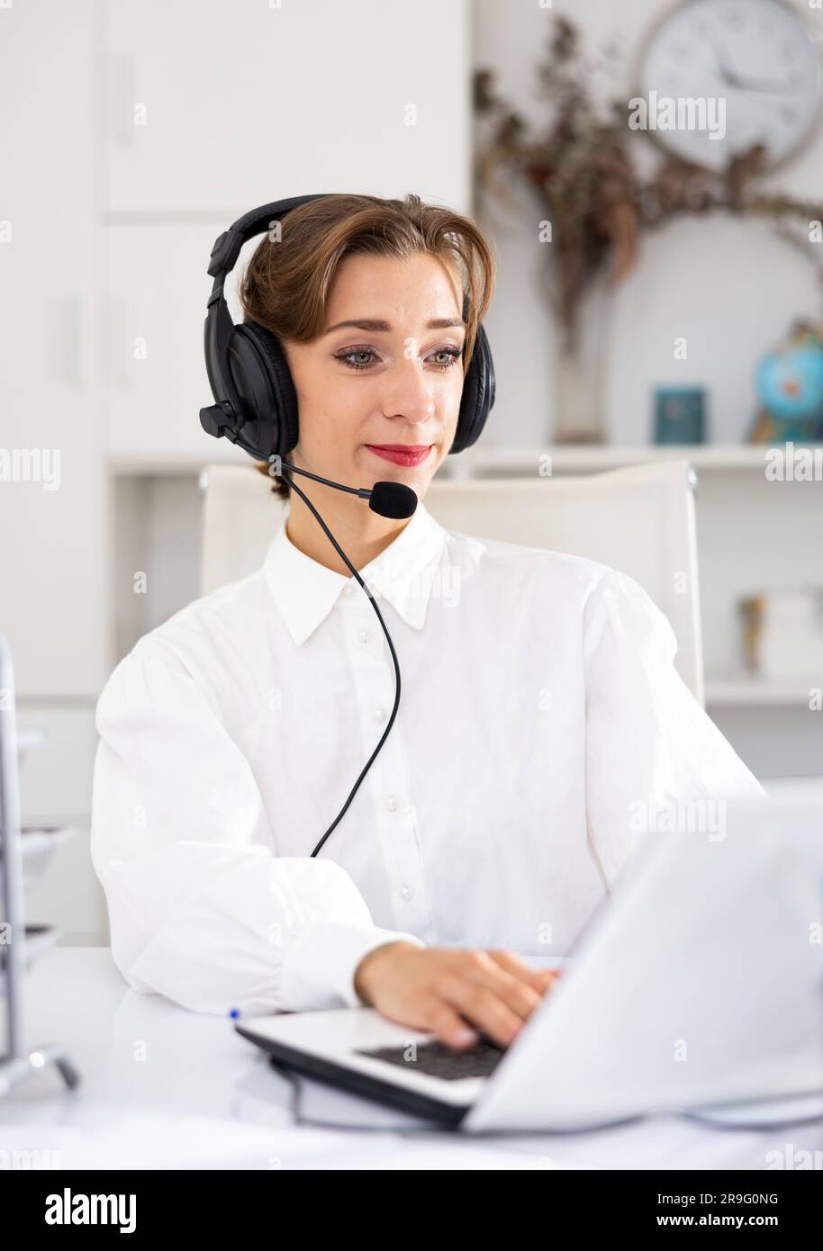 Call center operator talking with client and smiling Stock Photo - Alamy