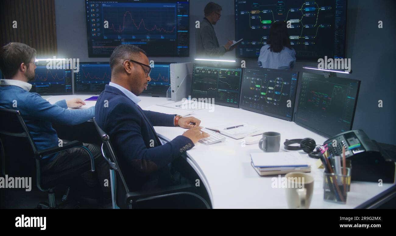 Software programmer sits in front of computer with blockchain network ... Software programmer sits in front of computer with blockchain network ...
