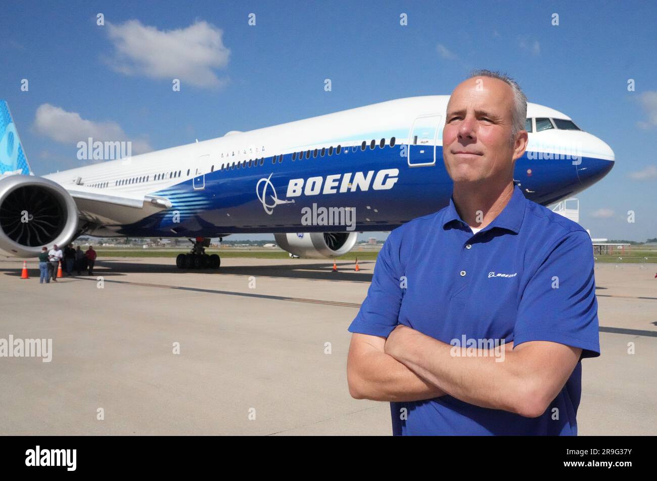 Pilot Ted Grady talks with reporters near his Boeing 777-9, commercial ...