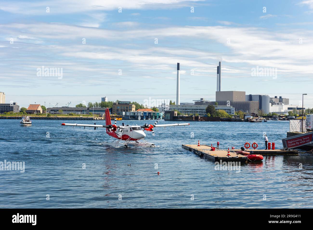 Small modern propeller business charter seaplane landing at Copenhagen ...