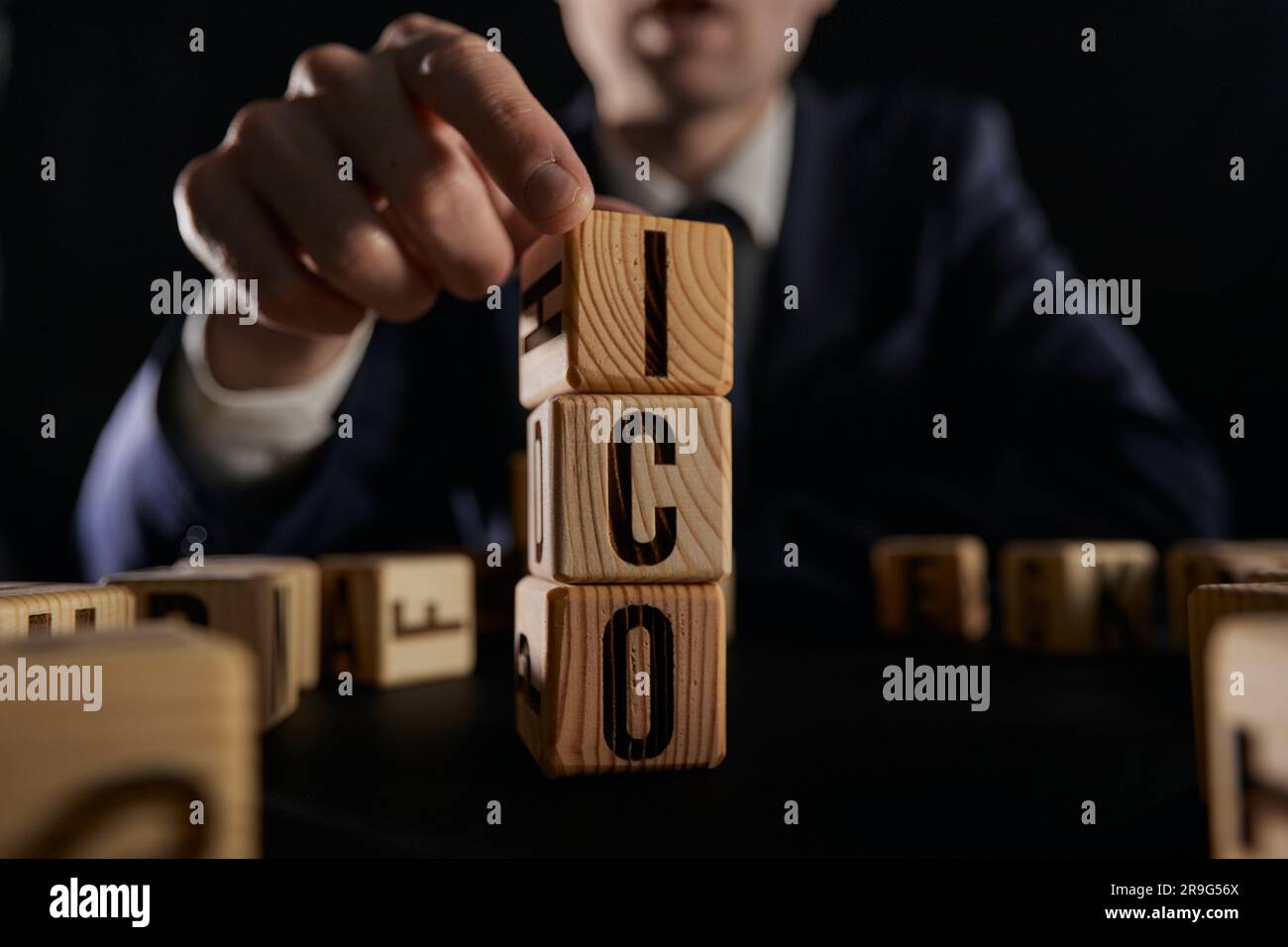 letters of the alphabet of ICO on wooden cubes, ICO - short for initial ...