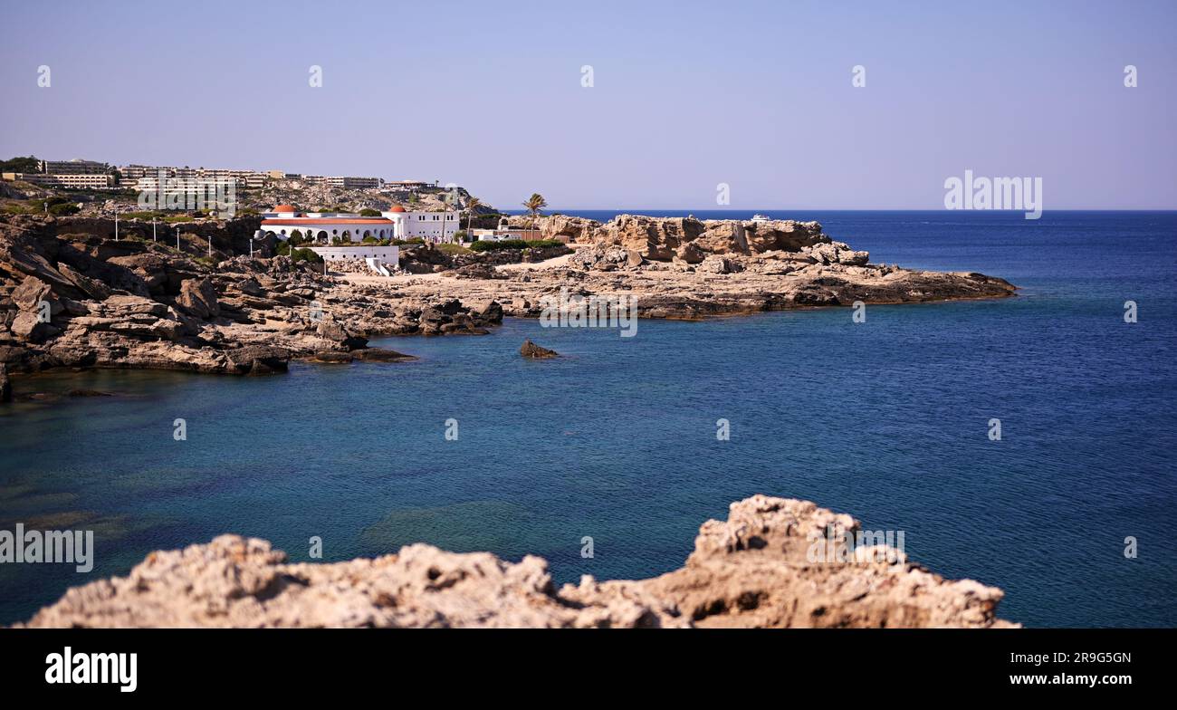 Sea coast of the Mediterranean Sea with a rocky beach and buildings ...