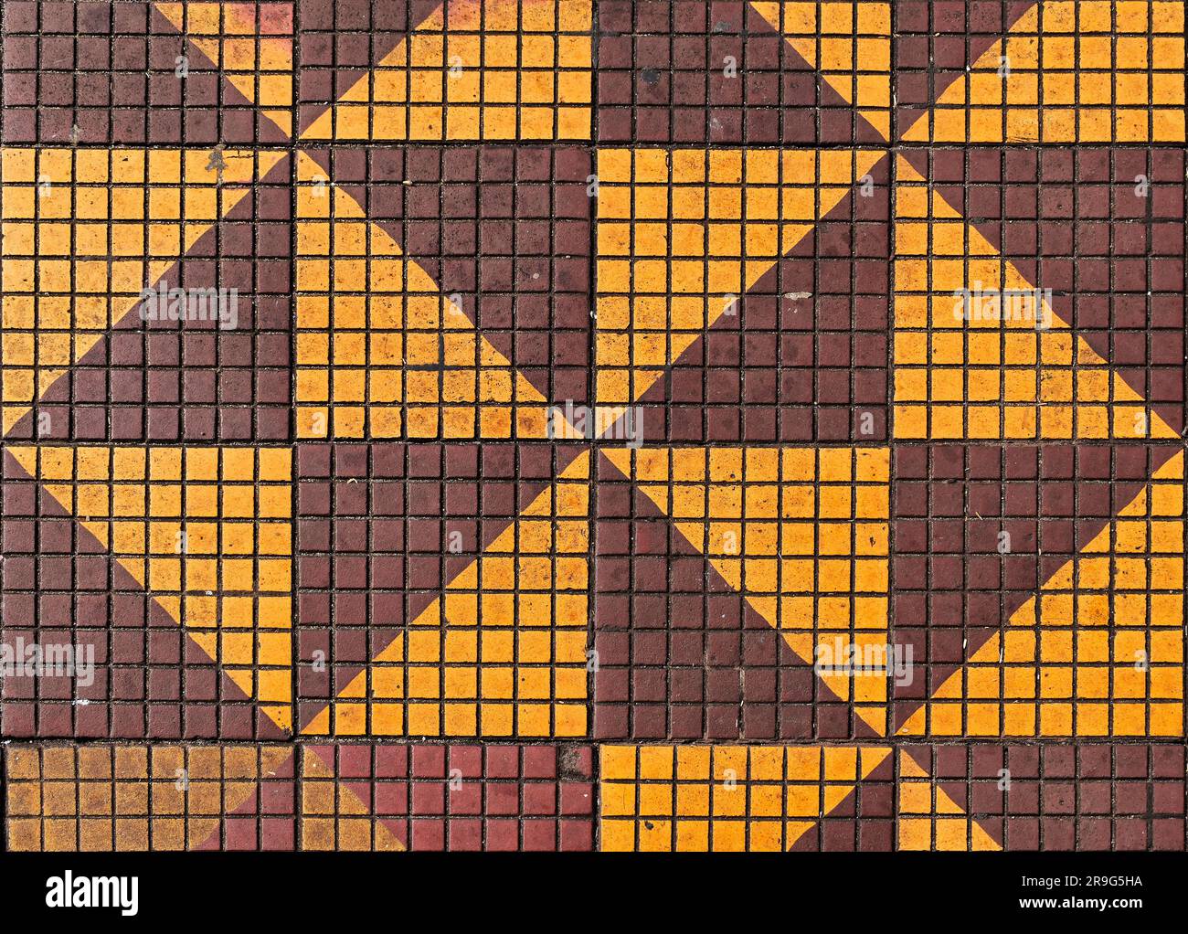 Red and yellow textured concrete blocks on floor Stock Photo - Alamy