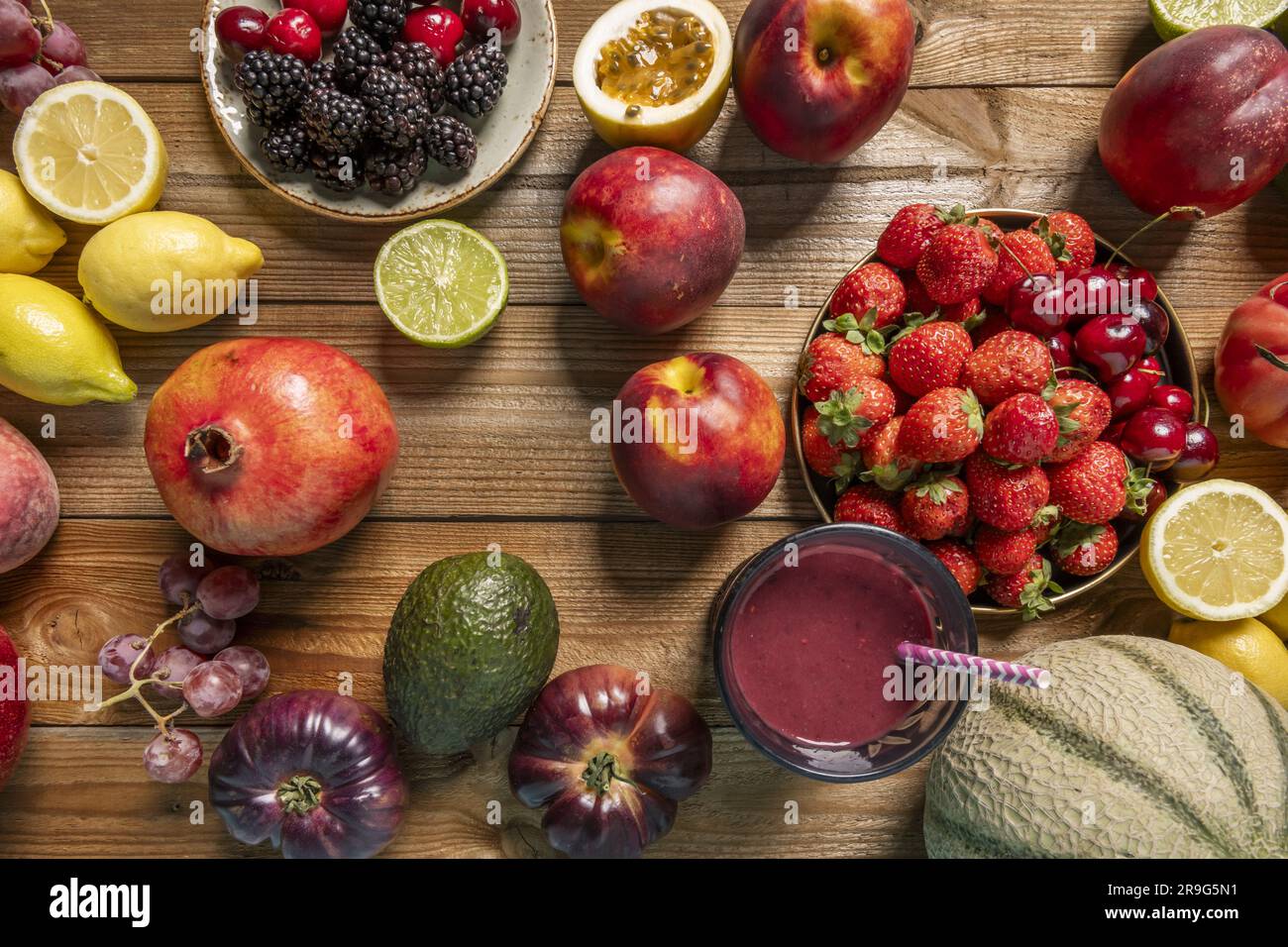 Delicious seasonal fruit still life with small lemons, a pomegranate ...