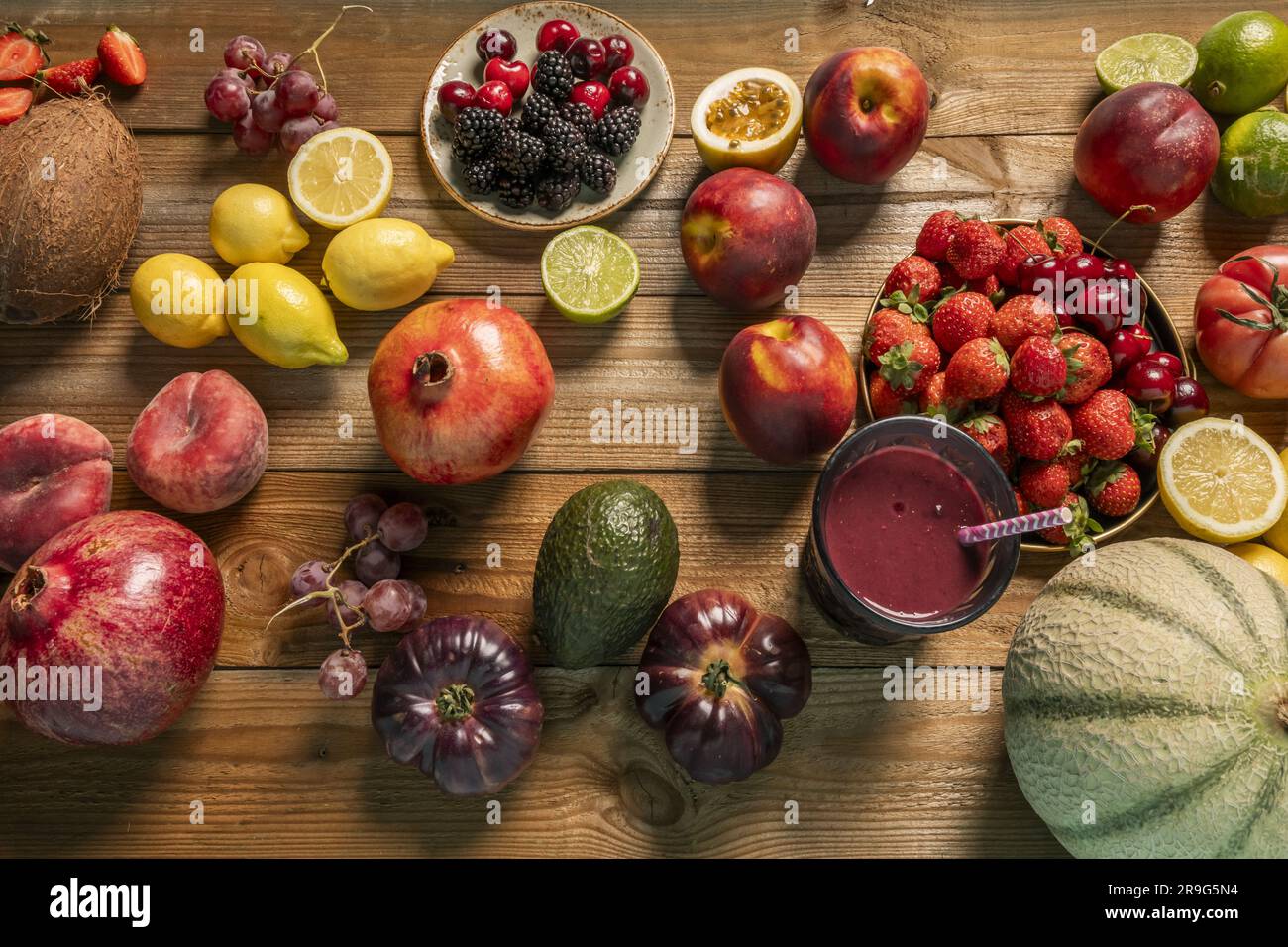 Delicious seasonal fruit still life with small lemons, a pomegranate ...