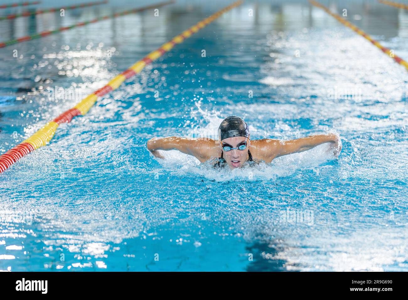 Front view of a powerful elite female swimmer competitor performing ...