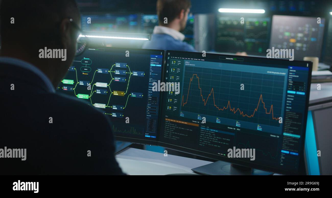 Multiracial team of IT software engineers work in monitoring office. Data server, blockchain ...