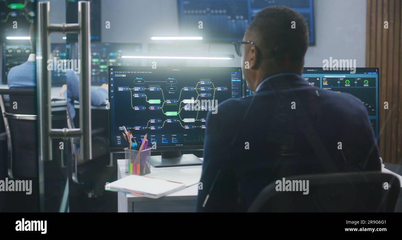 Technical support specialists sit at computers with displayed blockchain network map and server ...