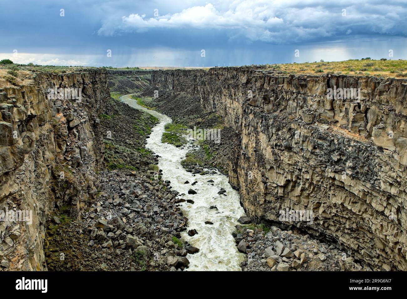 The Malad River winds through the famous Malad Gorge under a dramatic ...