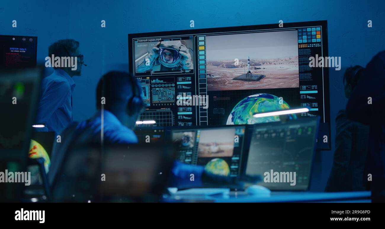 Flight control operators monitor space mission on computers in command ...