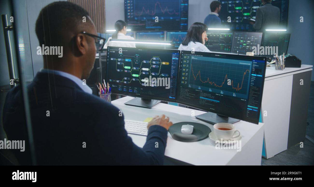African American big data scientist works at computer in monitoring ...