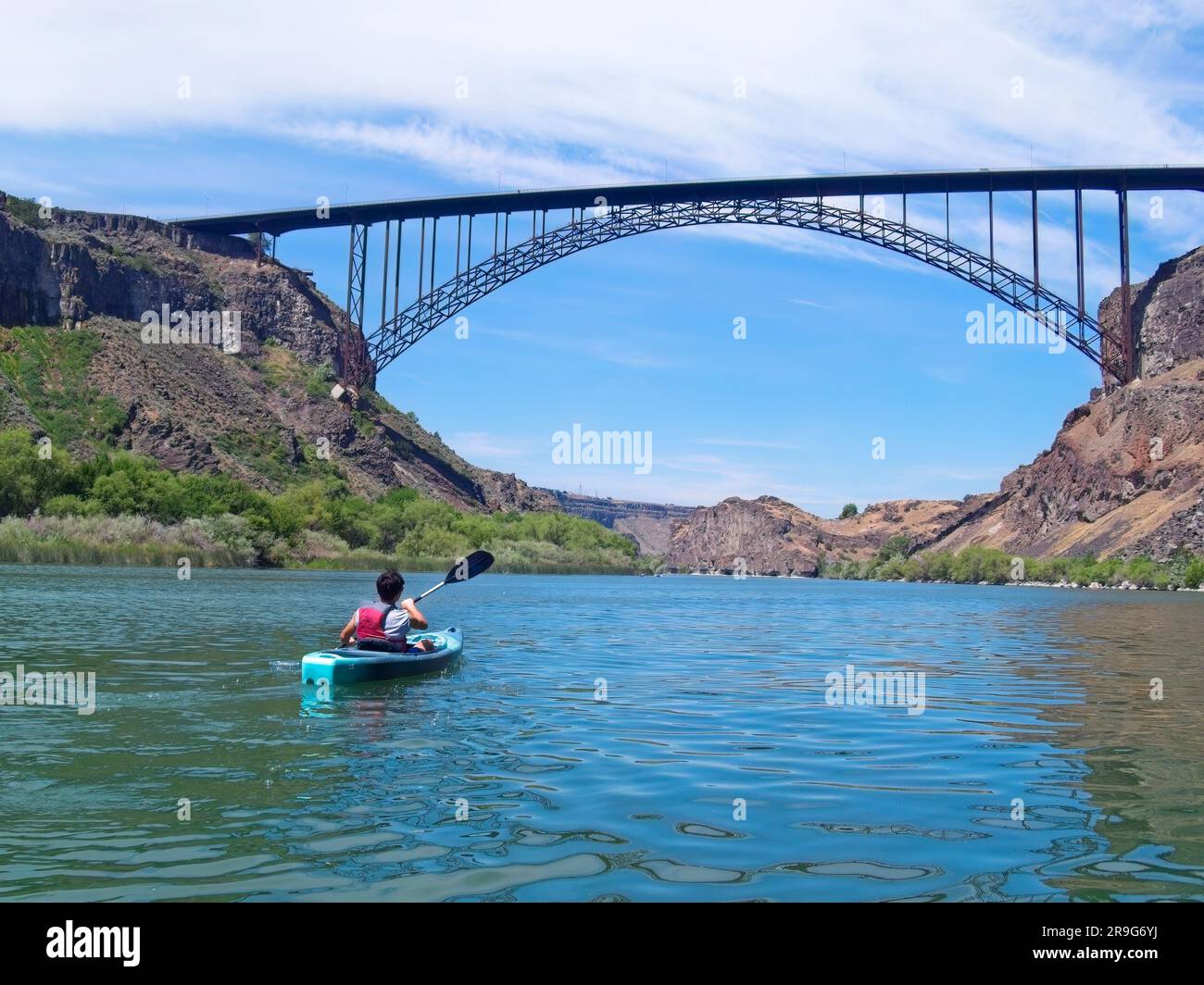 A teenage young man is paddling on the Snake River towards the Perrine ...