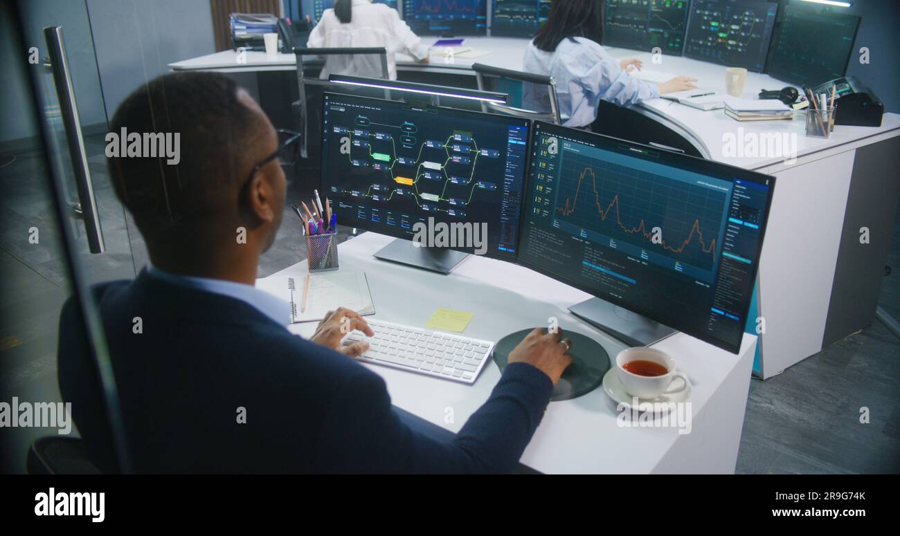 African American big data scientist works at computer in monitoring ...