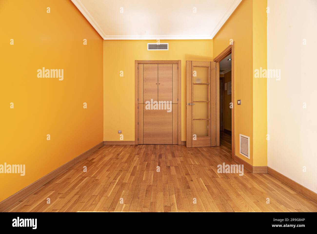 Empty living room with a serving hatch door to the kitchen and ducted ...